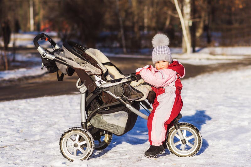 Little Child is Sitting in a Stroller in Winter Stock Image - Image of ...