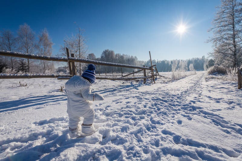Little Child in Snow Field. Little Child Boy Walking in Winter Field ...