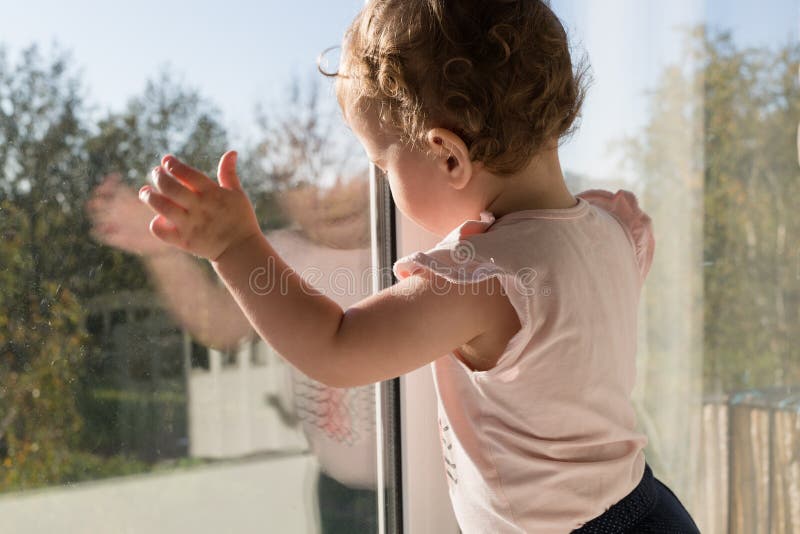 Sad child at the window stock image. Image of daughter - 20067605