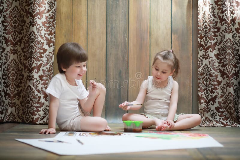 Little Children Paint on a Large Sheet of Paper Stock Photo - Image of ...