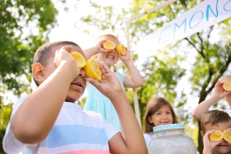 Little Children Playing while Preparing Fresh Lemonade in Park Stock ...