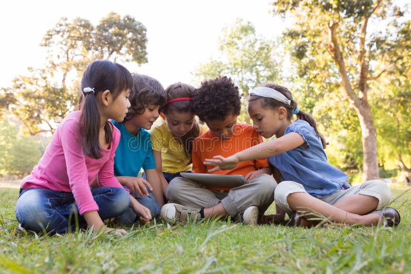Little Children Using Tablet in Park Stock Photo - Image of sitting ...