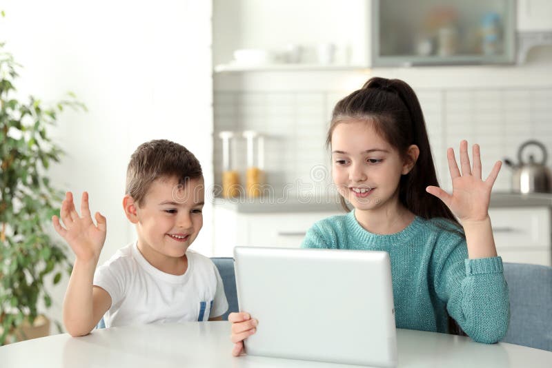 Little Children Using Video Chat on Tablet at Table Stock Photo - Image ...
