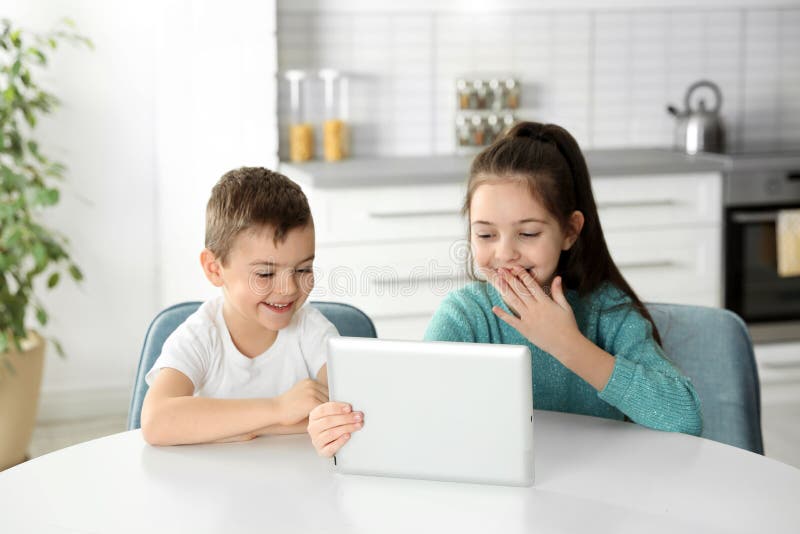 Little Children Using Video Chat on Tablet at Table Stock Image - Image ...