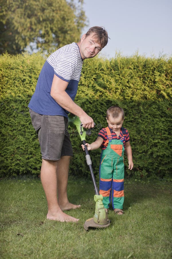 Little Craftsman with Father Using Several Power Tools in Garden Corner ...