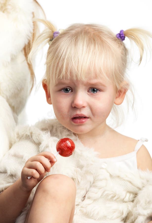Little Crying Girl with a Candy Over White Stock Image - Image of child ...