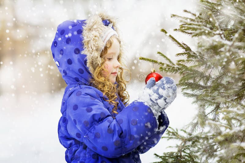 Little Curly Girl Decorates the Christmas Tree. Stock Photo - Image of ...