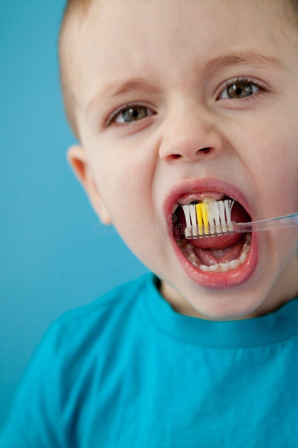 Little Cute Boy Brushing His Teeth on Blue Background Stock Image ...