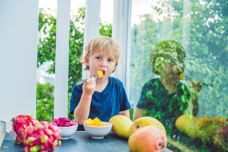Little Cute Boy Eating Mango on the Terrace Stock Image - Image of ...