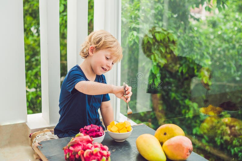 Little Cute Boy Eating Mango on the Terrace Stock Image - Image of blue ...