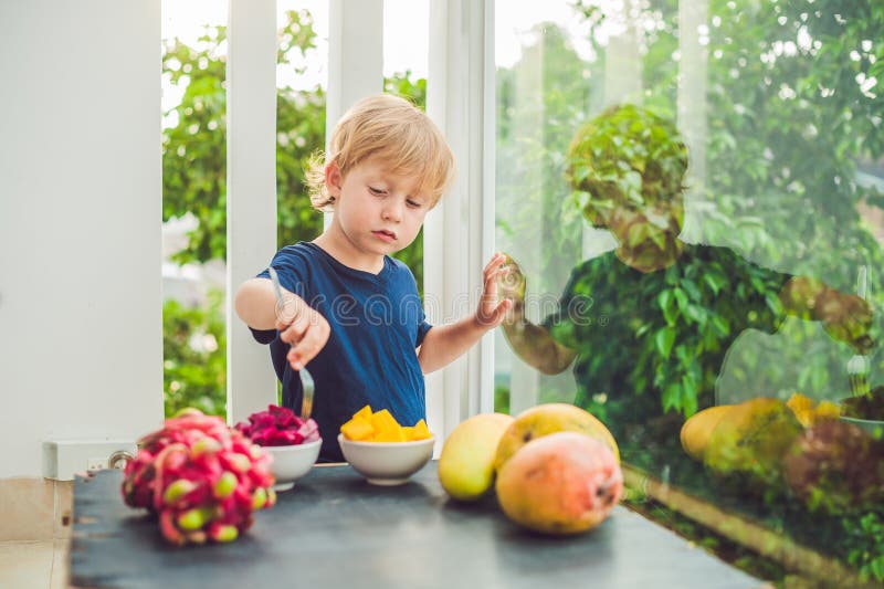 Little Cute Boy Eating Mango on the Terrace Stock Photo - Image of ...