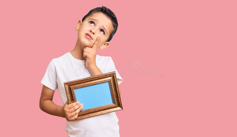 Little Cute Boy Kid Holding Empty Frame Serious Face Thinking about ...