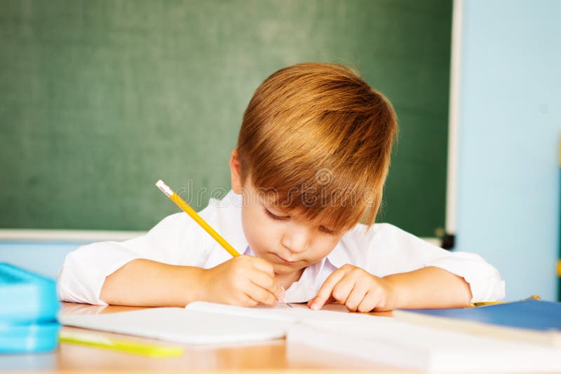 Little Cute Boy in School Writes in a Notebook Stock Photo - Image of ...