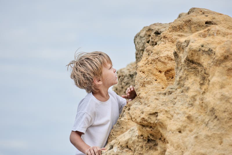 Boy playing with rocks stock photo. Image of mountaineering - 116197104