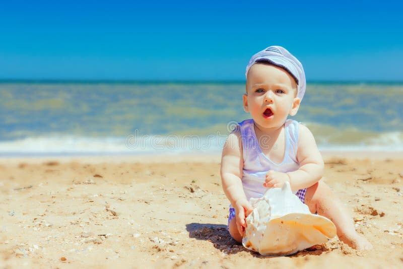 Baby Boy with Seashell in Hands at Beach Stock Image - Image of water ...