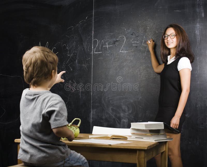 Little Cute Boy with Teacher in Classroom Stock Photo - Image of female ...
