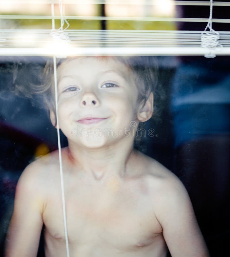 Little Cute Boy Throught Window Stock Photo - Image of opening, house ...