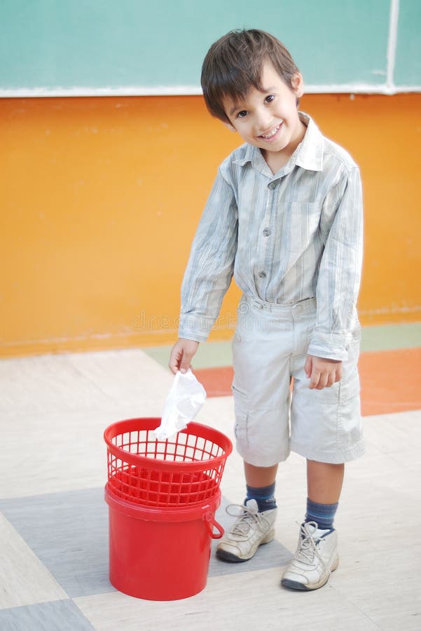 Child putting waste in bin stock photo. Image of garbage - 8578410