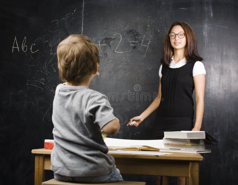 Little Cute Boy with Young Teacher in Classroom Stock Photo - Image of ...