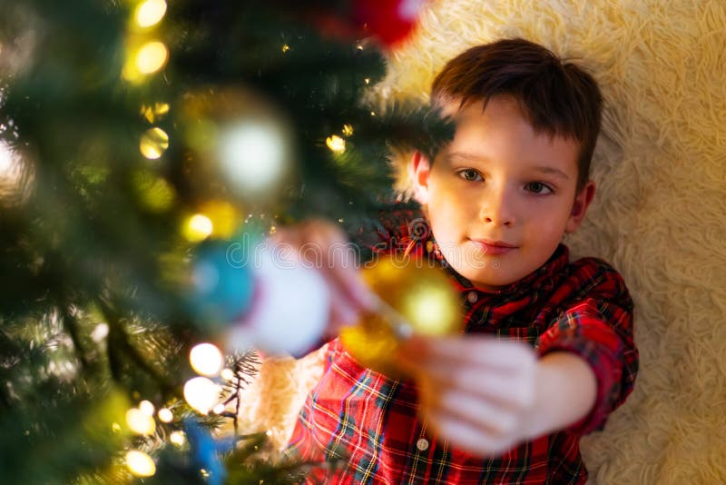 Little Cute Child Decorating the Christmas Tree on Christmas Eve at ...