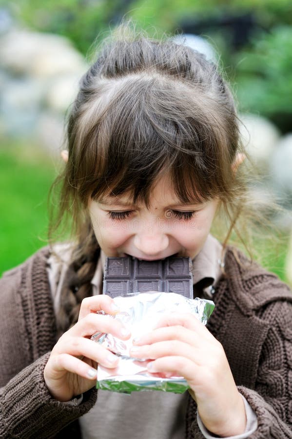 Little Cute Girl Eating Chocolate Stock Photo - Image of outdoors, food ...