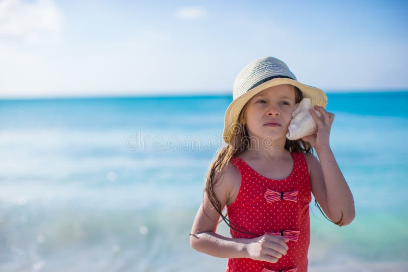 Little Cute Girl with Seashell in Hands at Stock Image - Image of ...