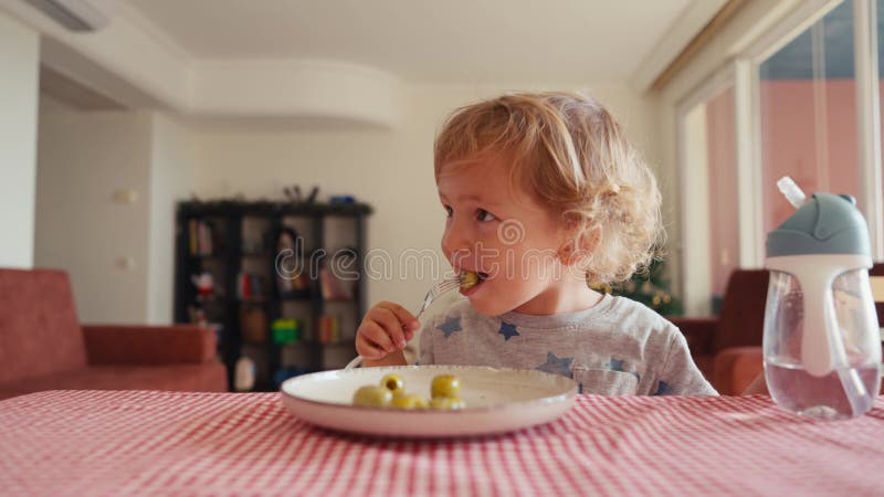 Little Cute Kid with Appetite Eats Olives Itself with Fork Stock ...