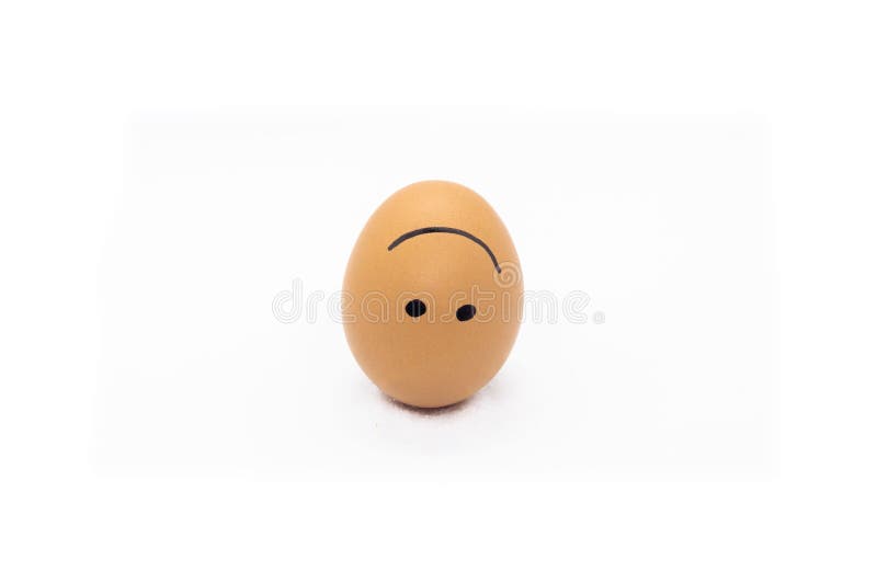 A Little Face on an Egg that is Sitting on the Floor Stock Photo ...