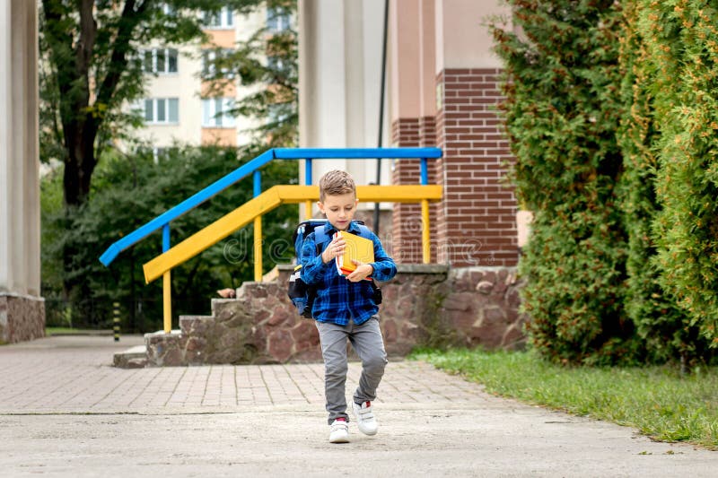 Little First Grader with Backpack Looking the Copybook, Going Home from ...