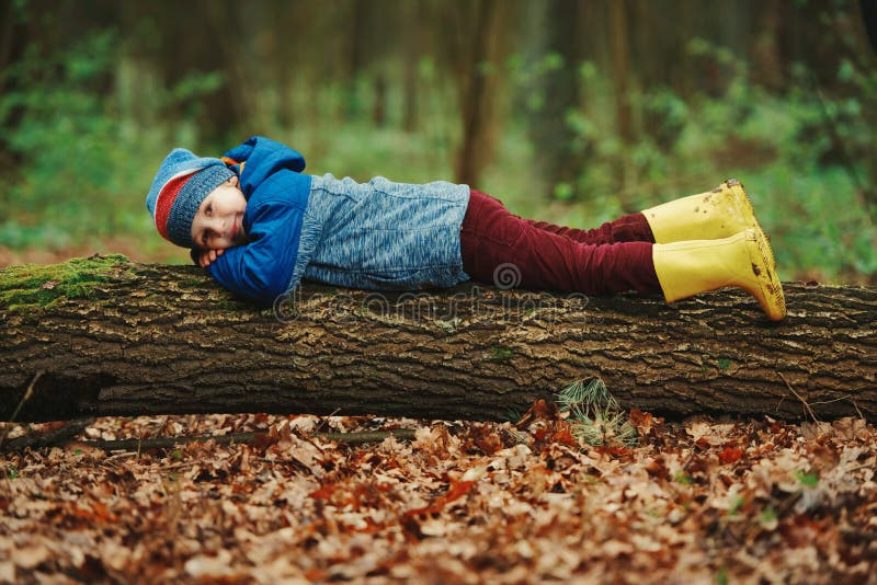 Little Funny Boy on Big Log Stock Image - Image of happy, park: 93044173