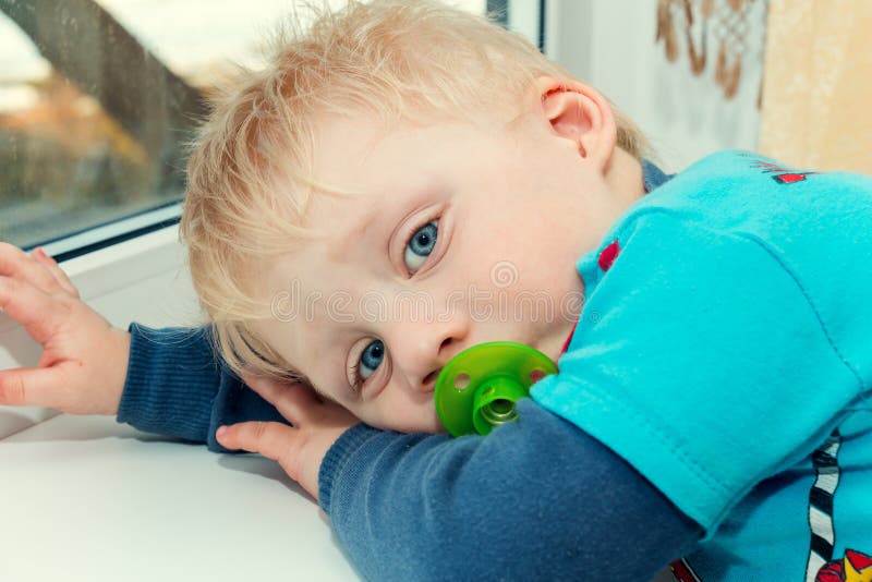 Little Funny Boy with a Pacifier. Stock Photo - Image of interior, face ...