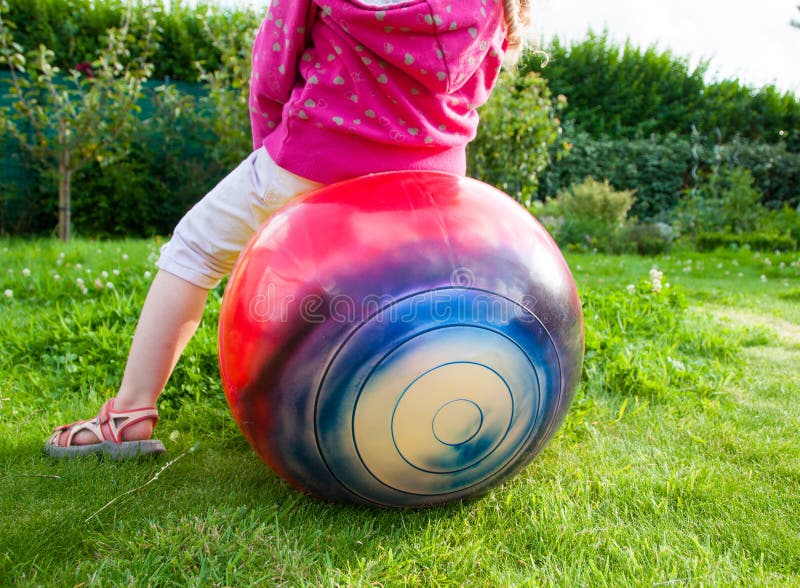 Happy Kid Girl Jumping on Bouncing Ball Stock Photo - Image of ...