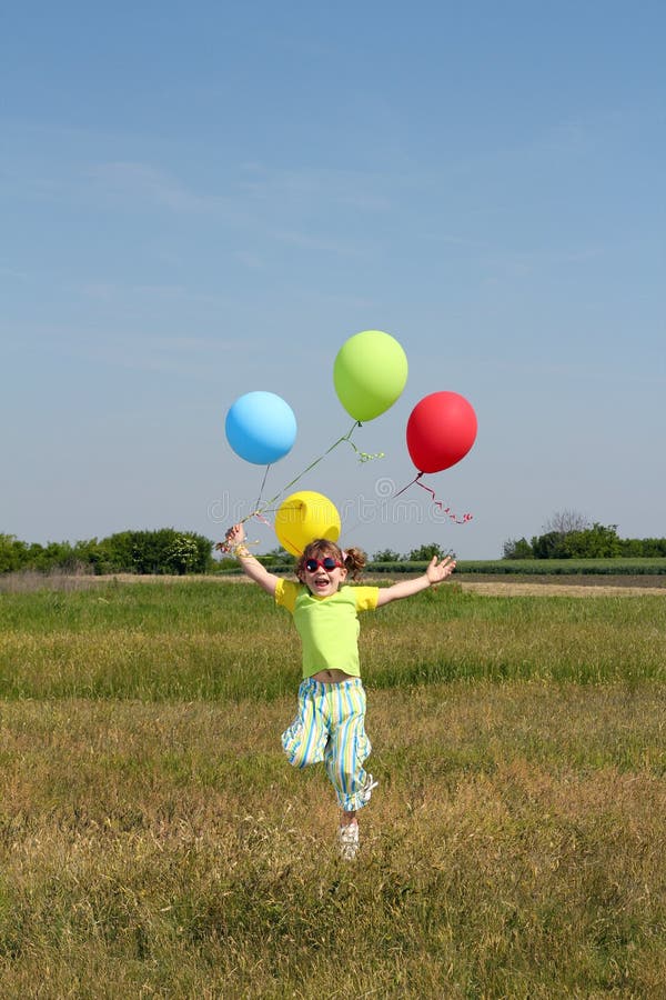Happy Toddler Running with Balloons in Field Stock Photo - Image of ...