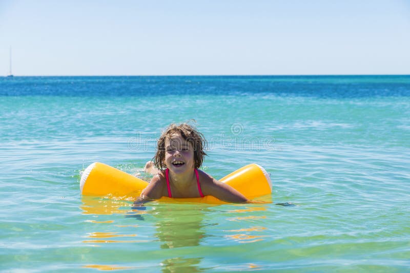 Little Girl Bathing with a Float on the Beach Stock Photo - Image of ...