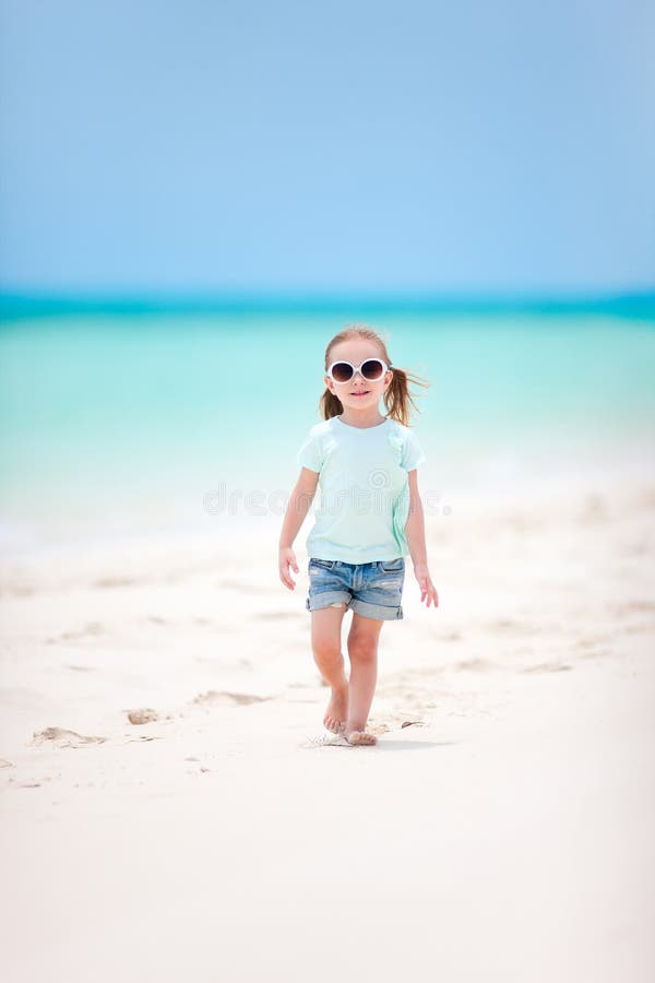 Nice Dressed Blond Little Girl on the Beach in the Summertime Looking ...