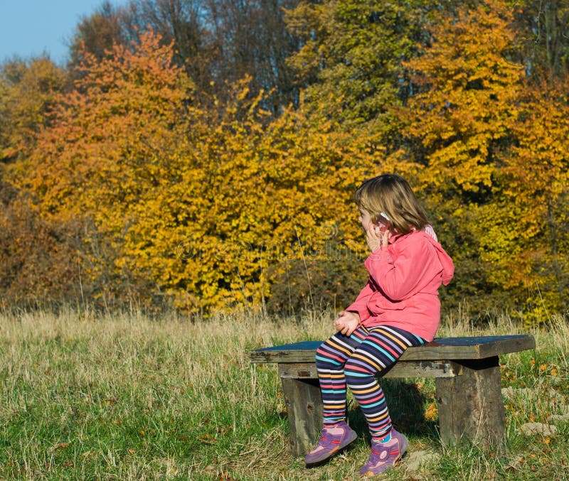 Little girl on the bench stock image. Image of pink, woods - 21925417