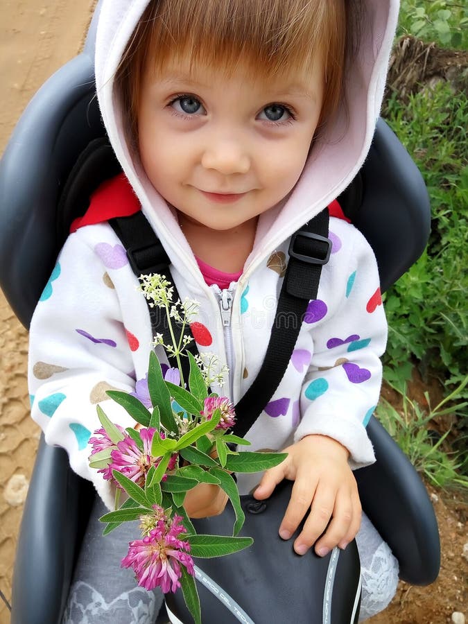 Little Girl on the Bicycle with a Bouquet of Flowers Stock Image ...