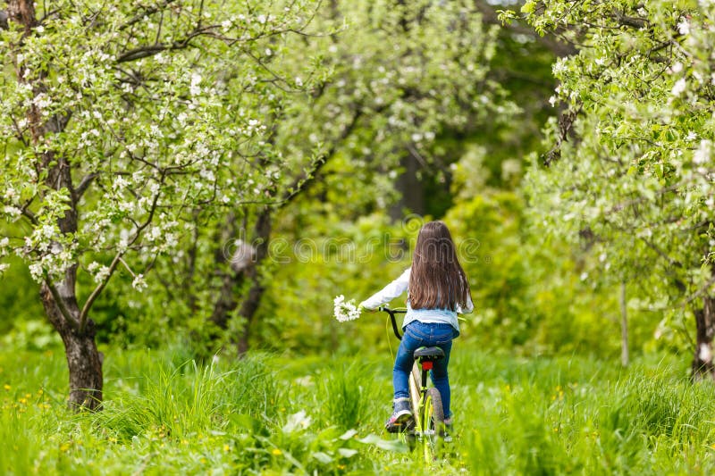 Little Girl with Bicycle Near Tree with Blossoms Stock Photo - Image of ...