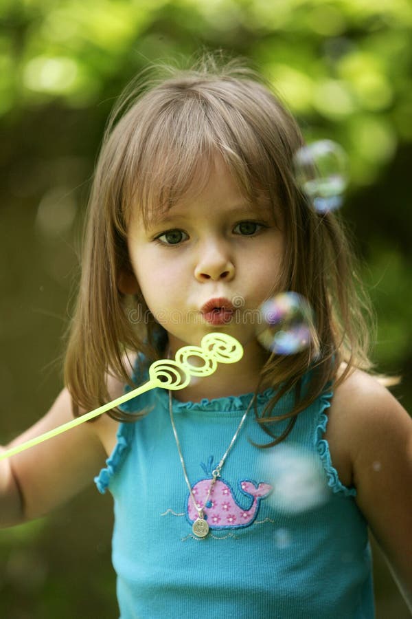 Little Girl Blowing Bubbles Outside Stock Image - Image of bubbles ...