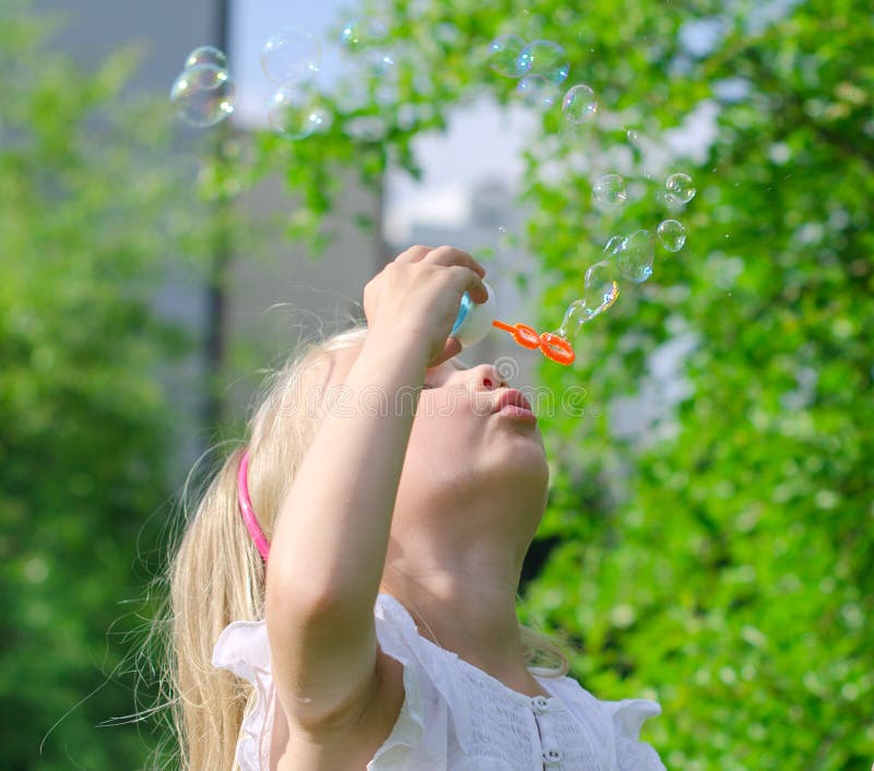 A Little Girl Blowing Soap Bubbles Stock Photo - Image of human, lovely ...