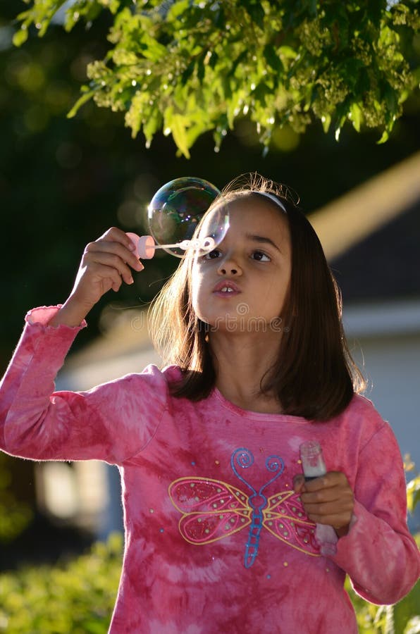 Little girl blows a bubble stock image. Image of beauty - 19676935