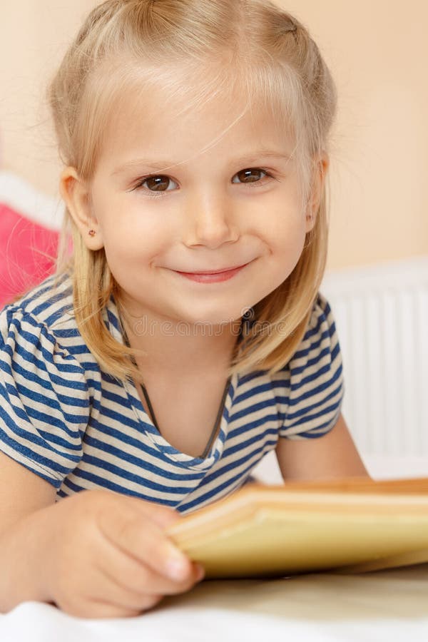 Little girl with a book stock image. Image of inspiration - 62595397