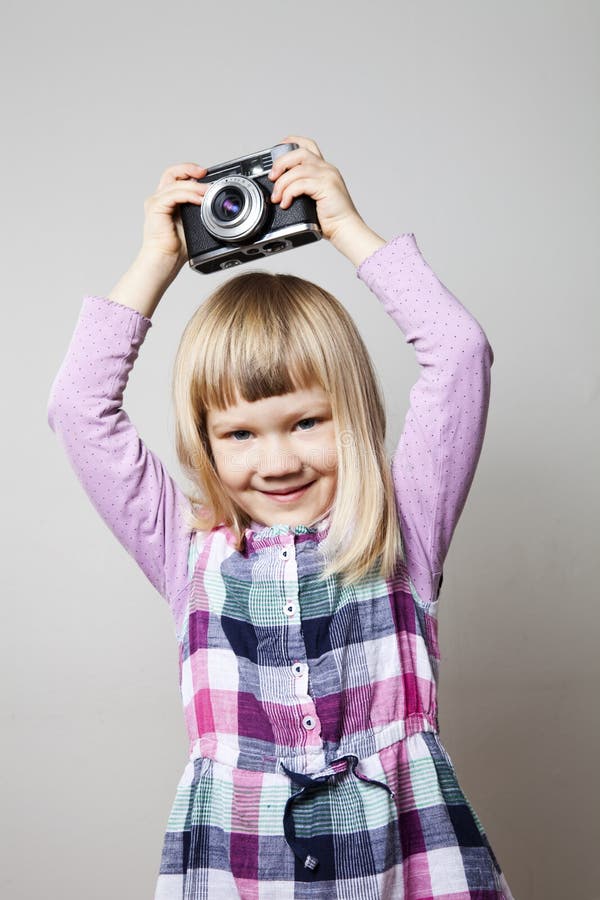 Little girl with camera stock photo. Image of childhood - 23397394