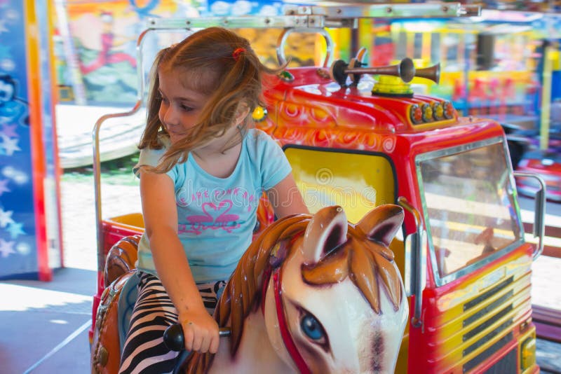 Little girl in carousel stock photo. Image of lifestyle - 80642716