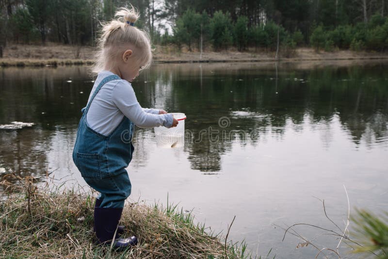 Little Girl Catches and Feeds Fish Stock Photo - Image of catch, fish ...