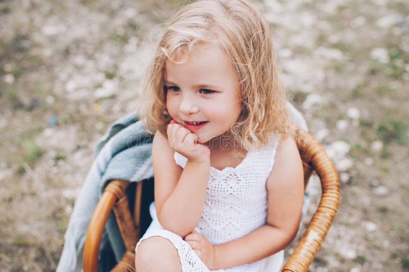 The Girl on the Chair Watches Tv in the Field and Drinks Stock Photo ...