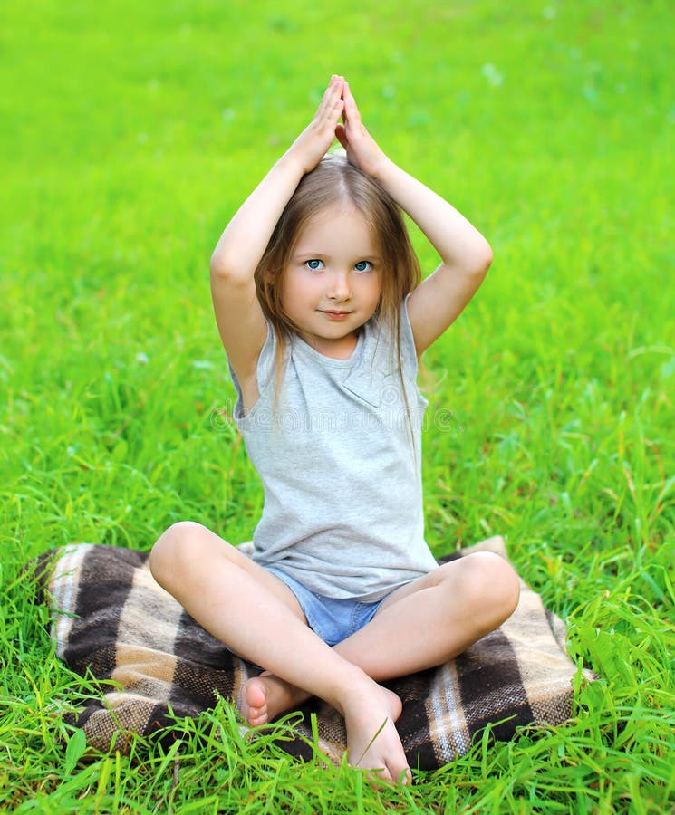 Little Girl Child on the Grass Does Yoga Exercise Stock Image - Image ...