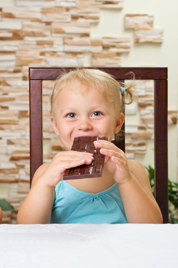 Little Girl with Chocolate at Light Room Stock Photo - Image of candy ...