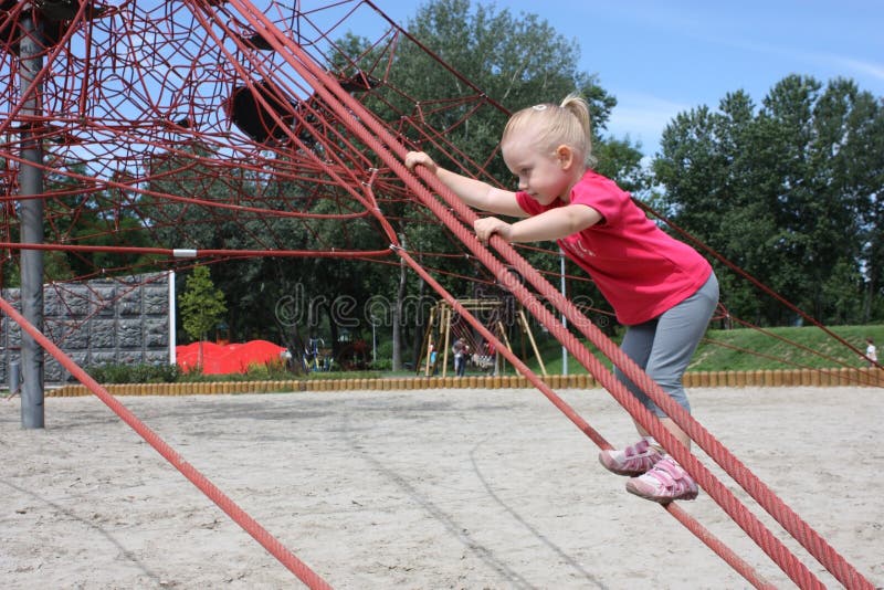 Little Girl Climbing through the Web of Ropes Stock Photo - Image of ...