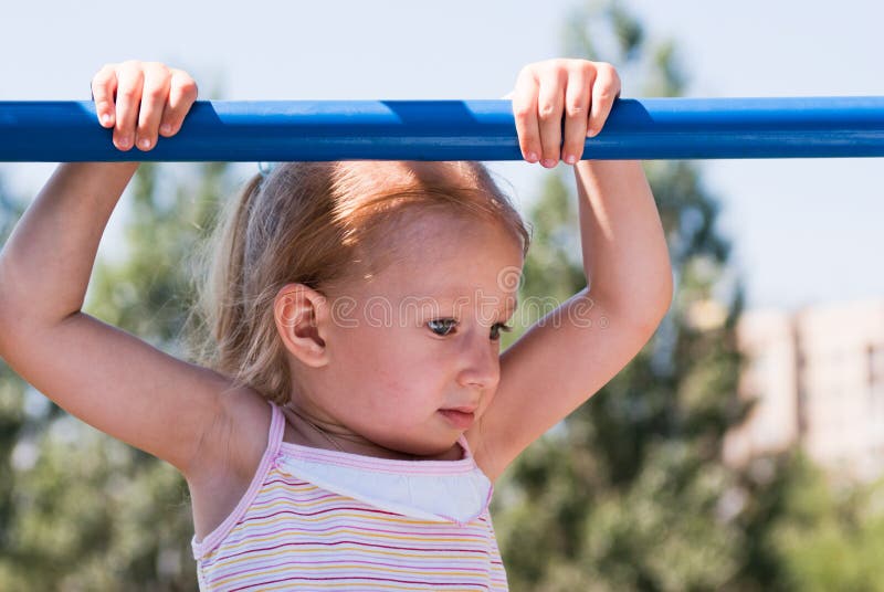 A Little Girl Clings To the Bar Stock Image - Image of small, close ...